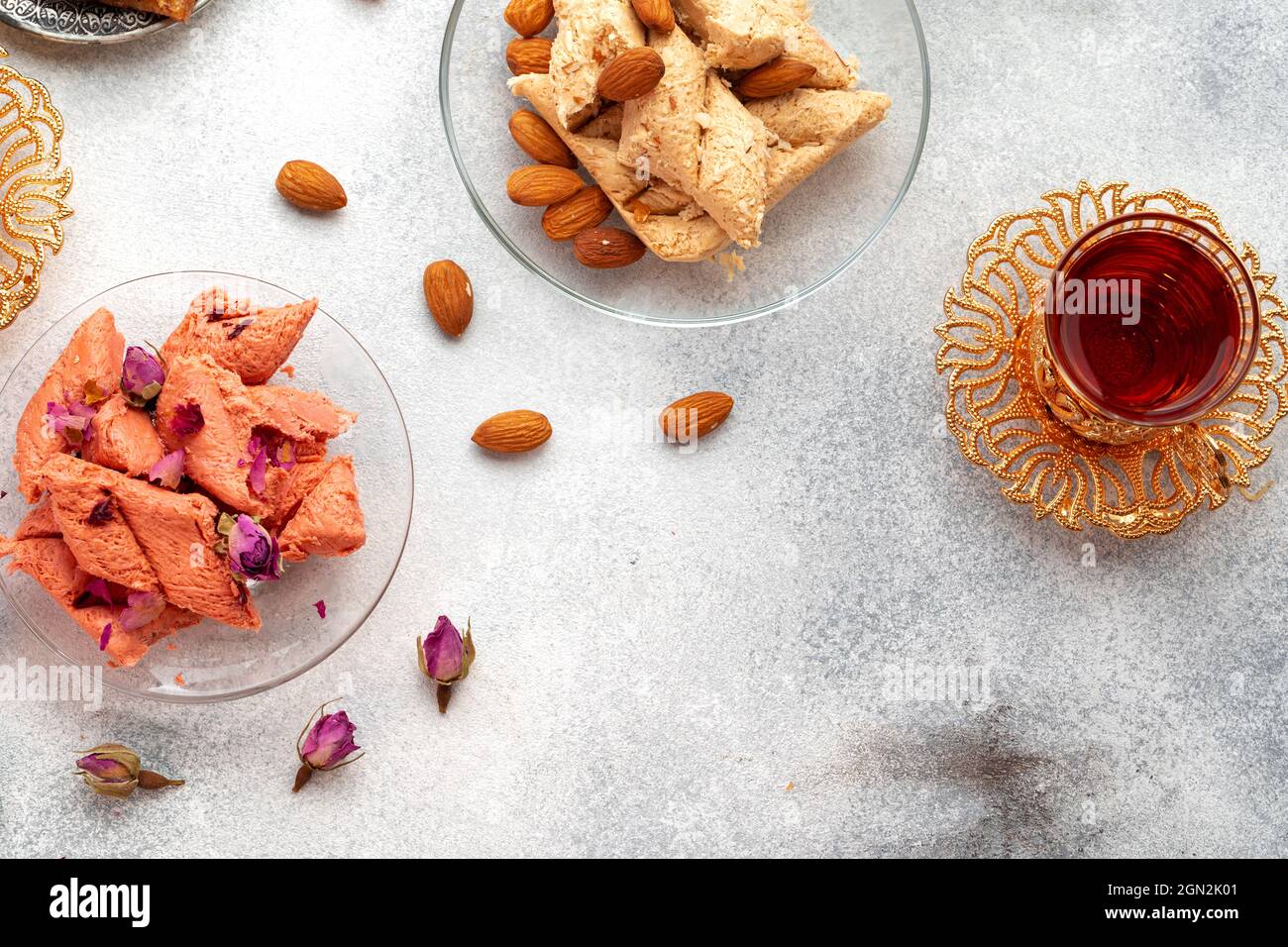Assortment of Turkish delights with glass of tea on gray background ...