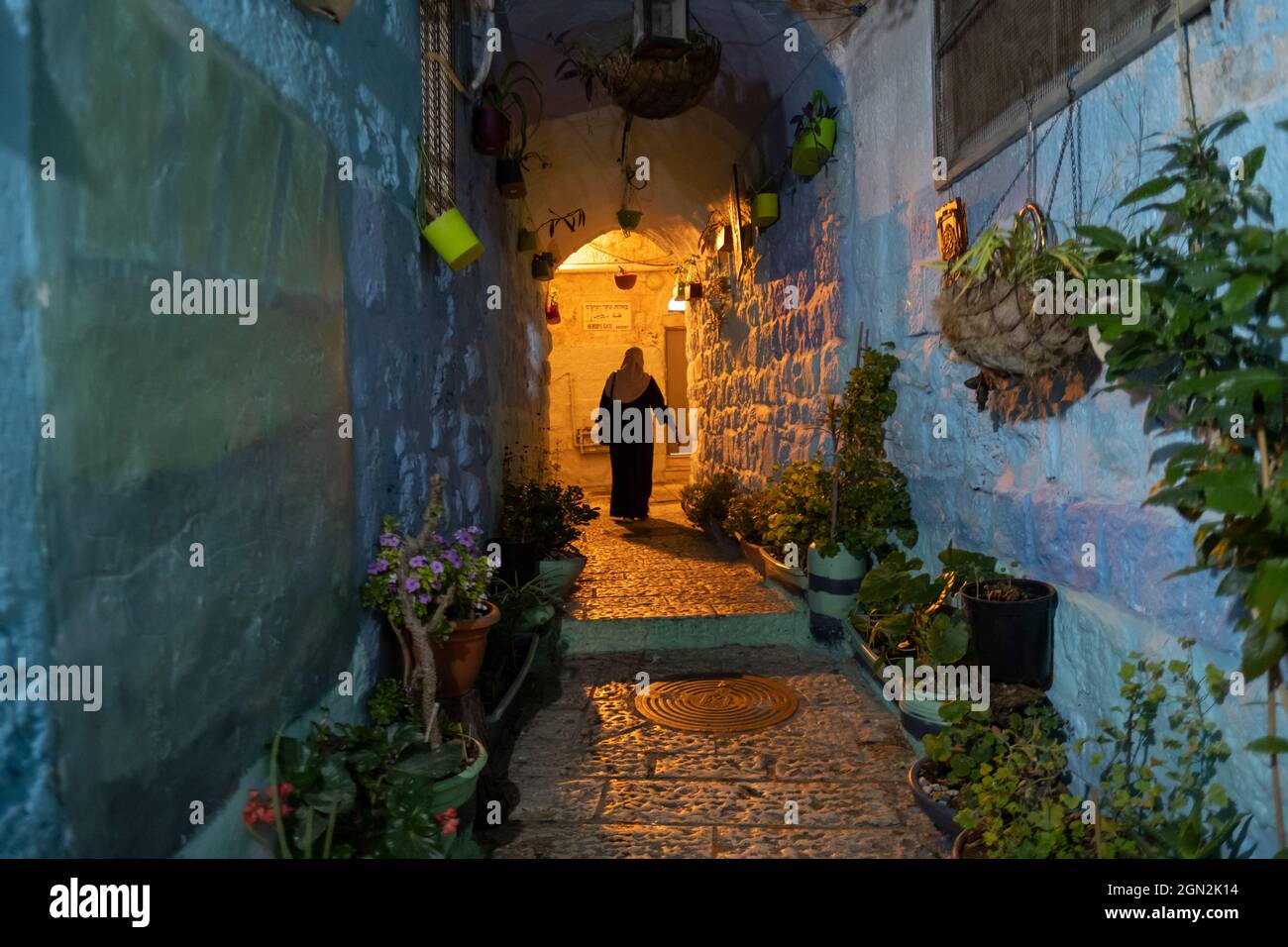 A Palestinian woman walks in an alley in the Muslim Quarter Old city ...