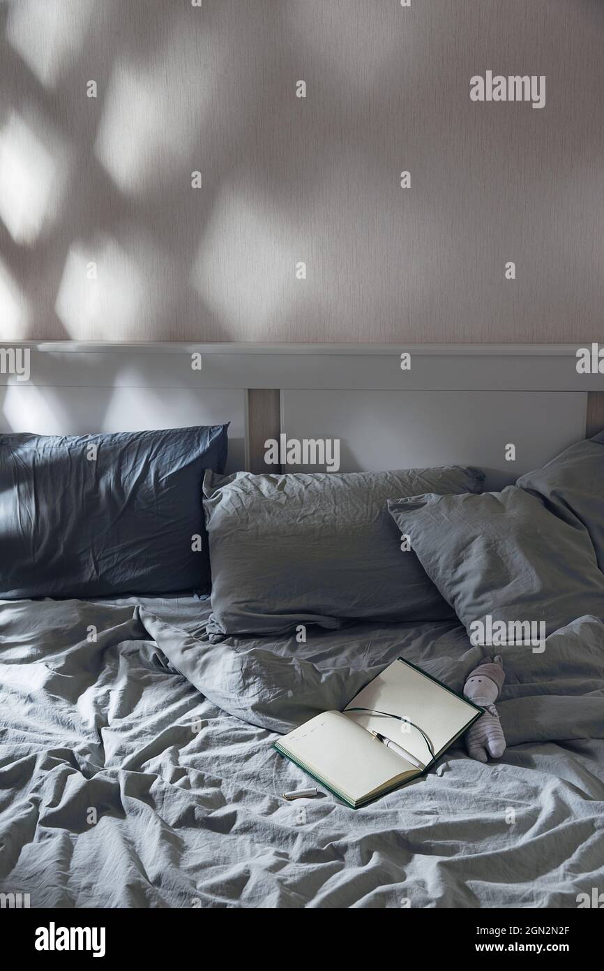 Open diary to write on the bed with blue textiles in the moonlight ...