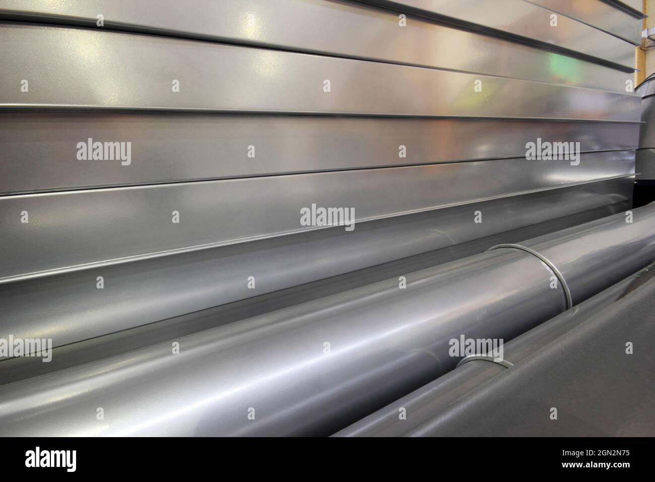 Round and angular galvanized pipes Stock Photo - Alamy