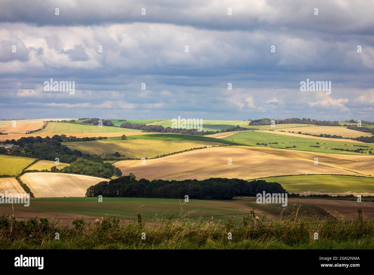 Patches of afternoon sunlight hitting the farmland of the south downs ...