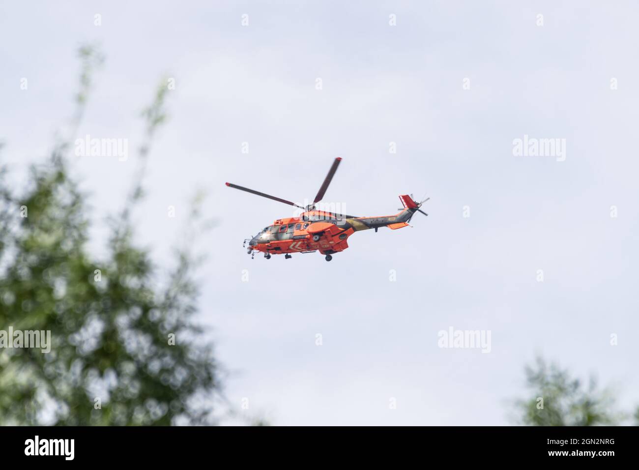 Fire brigade emergency helicopter carrying out a water refuelling ...