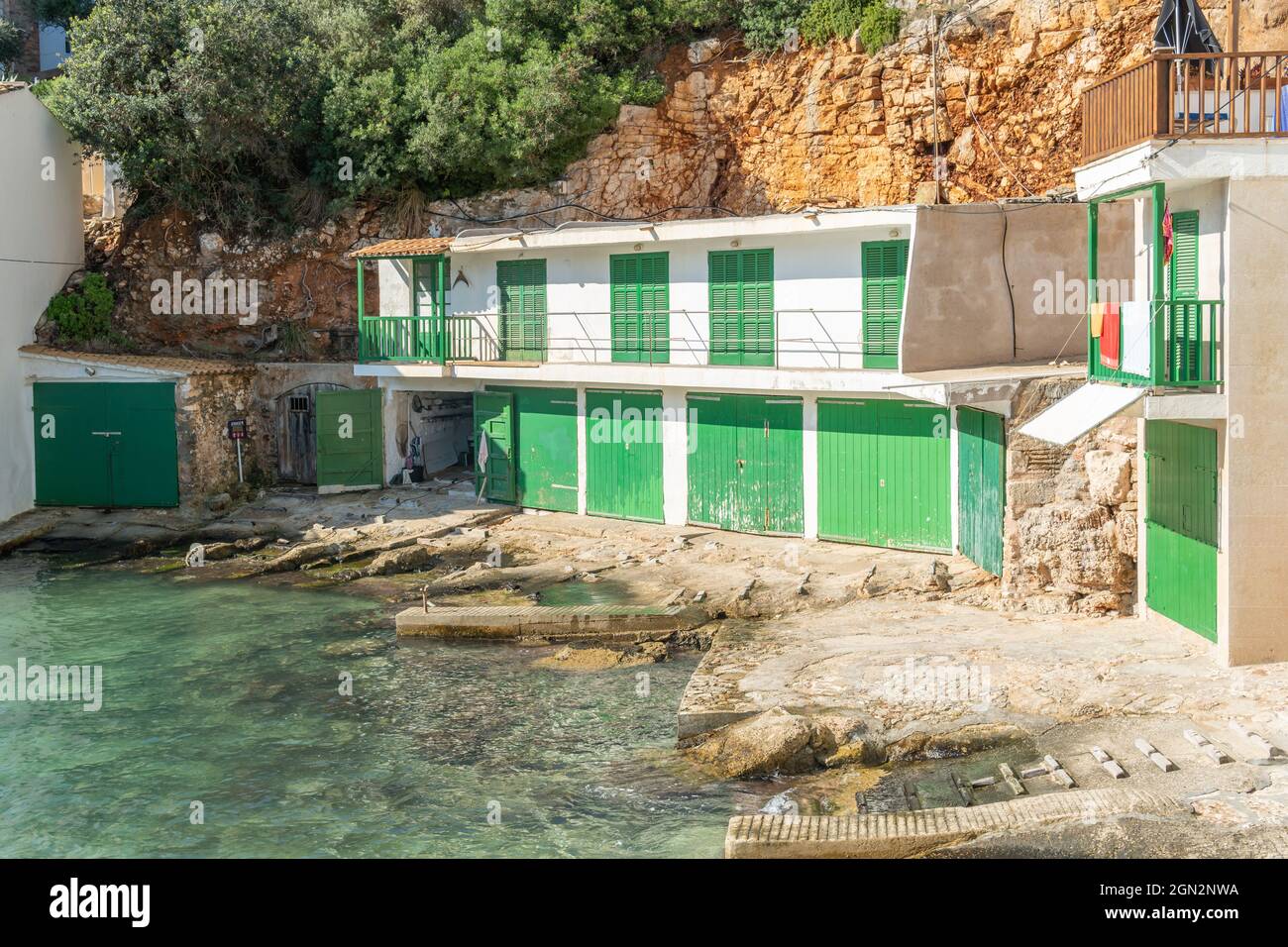 Traditional white jetties on the island of Mallorca with green doors at ...