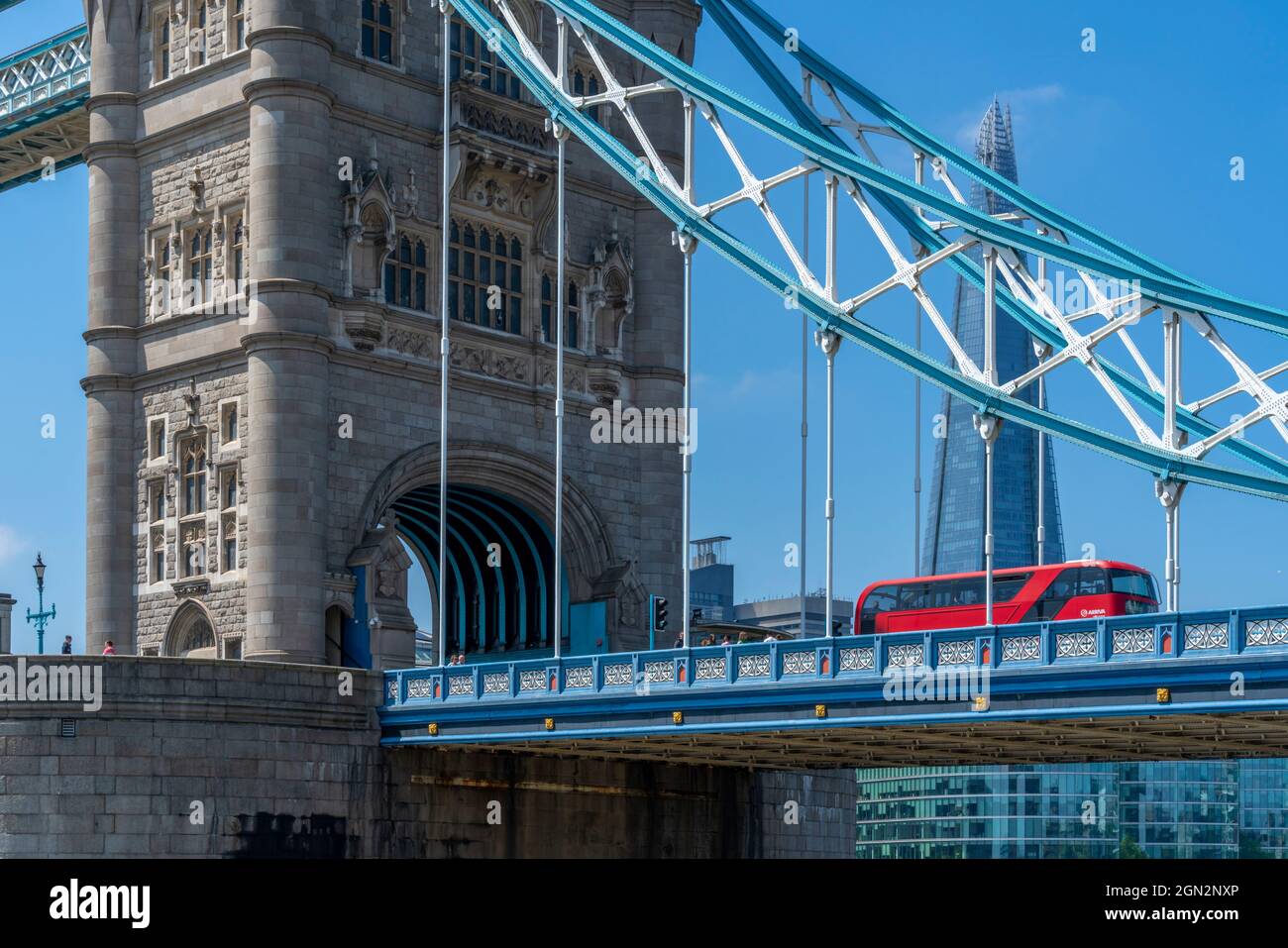 View of red bus on Tower Bridge and the Shard in background, London ...