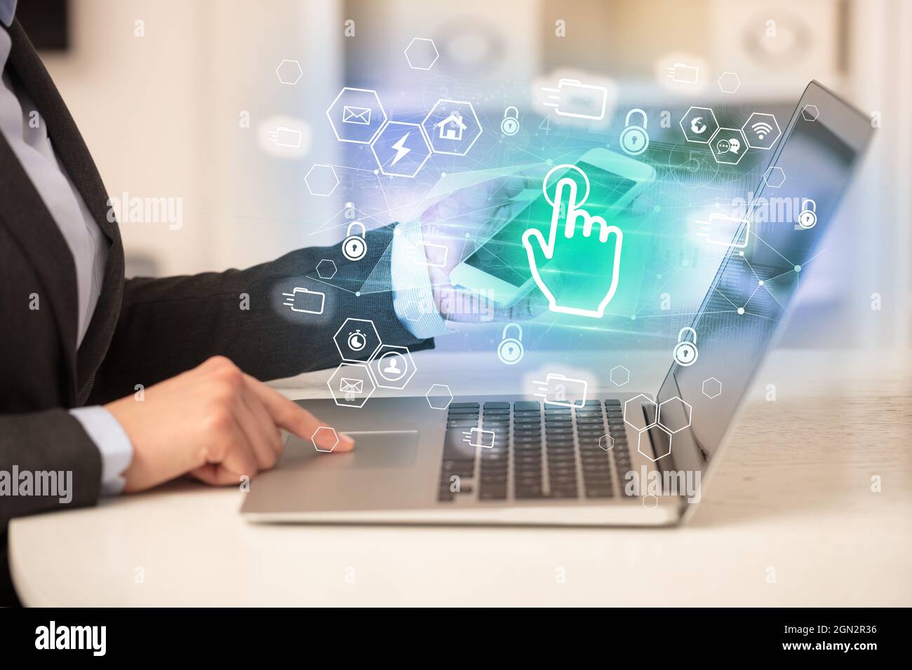 Hands working on laptop with digital icons Stock Photo - Alamy