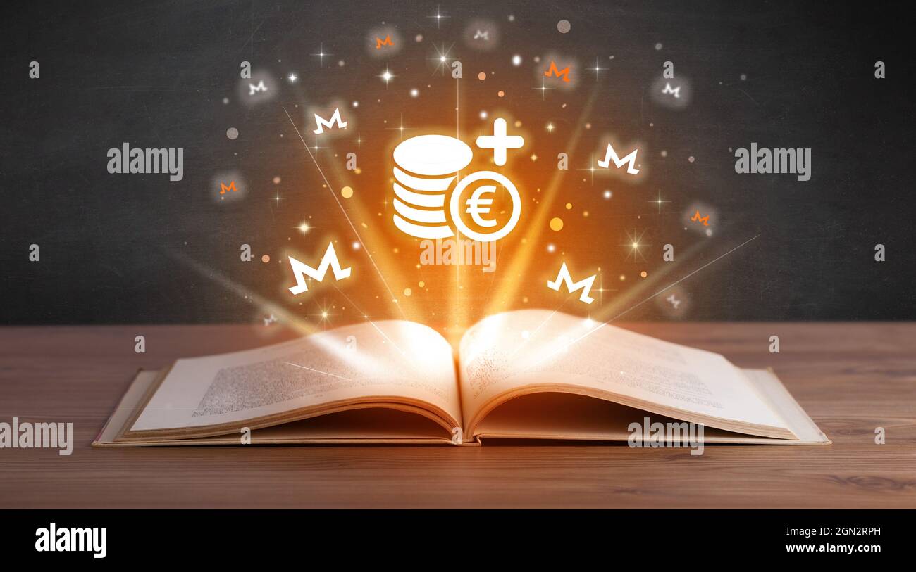 Open book with currency icons above Stock Photo - Alamy
