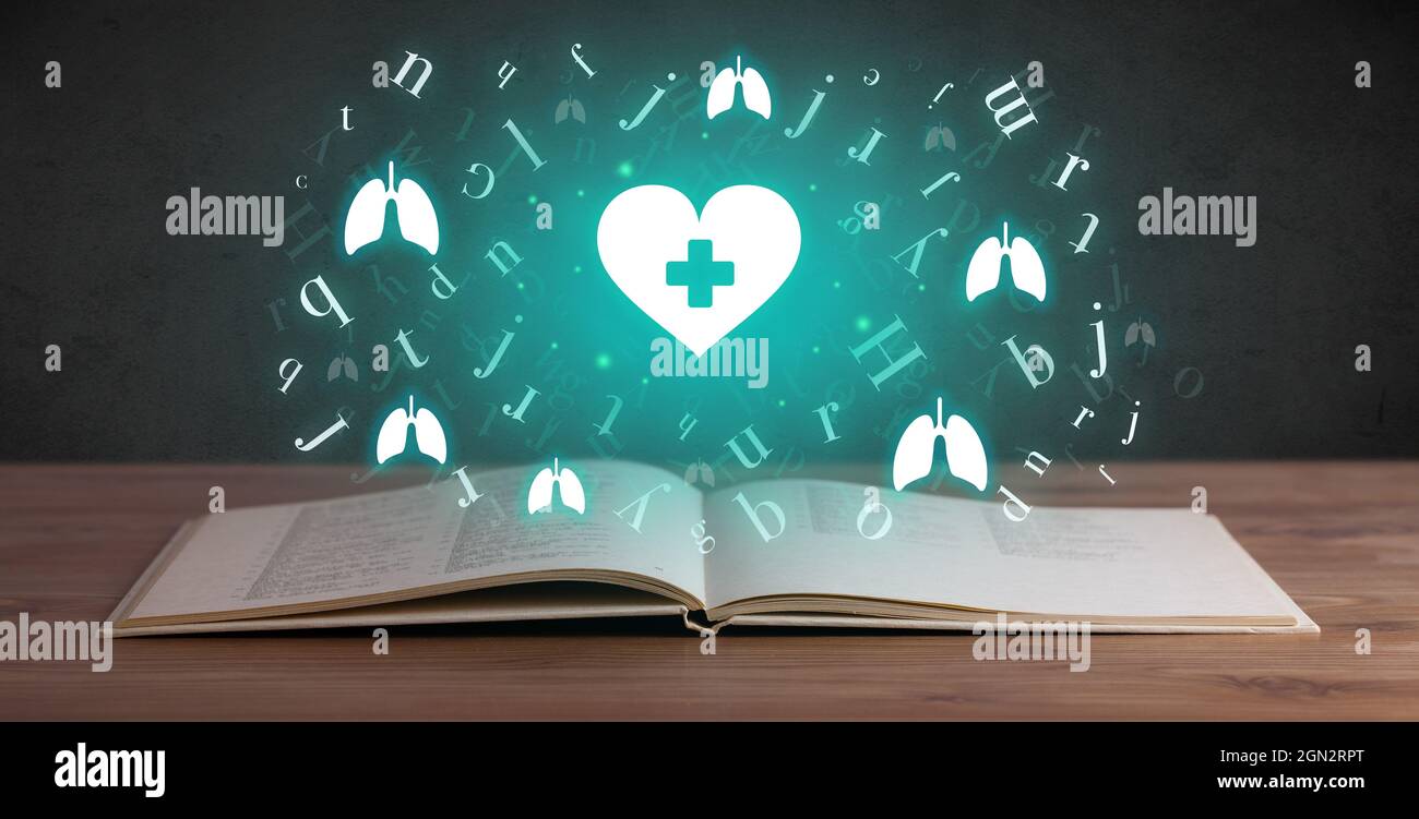 Open medical book with health icons above Stock Photo - Alamy