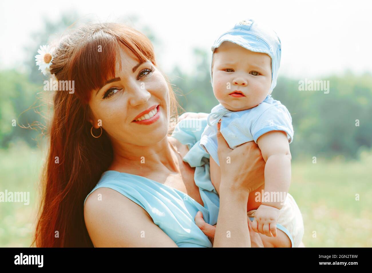 mother raises the child in her arms Stock Photo - Alamy