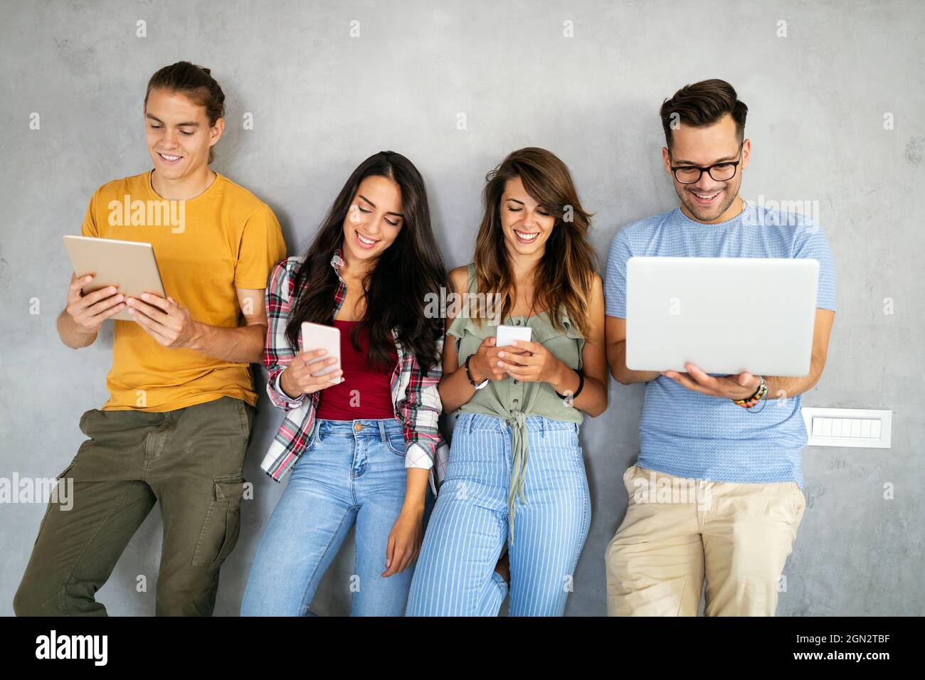 Happy young people working, using digital devices. Technology, people ...