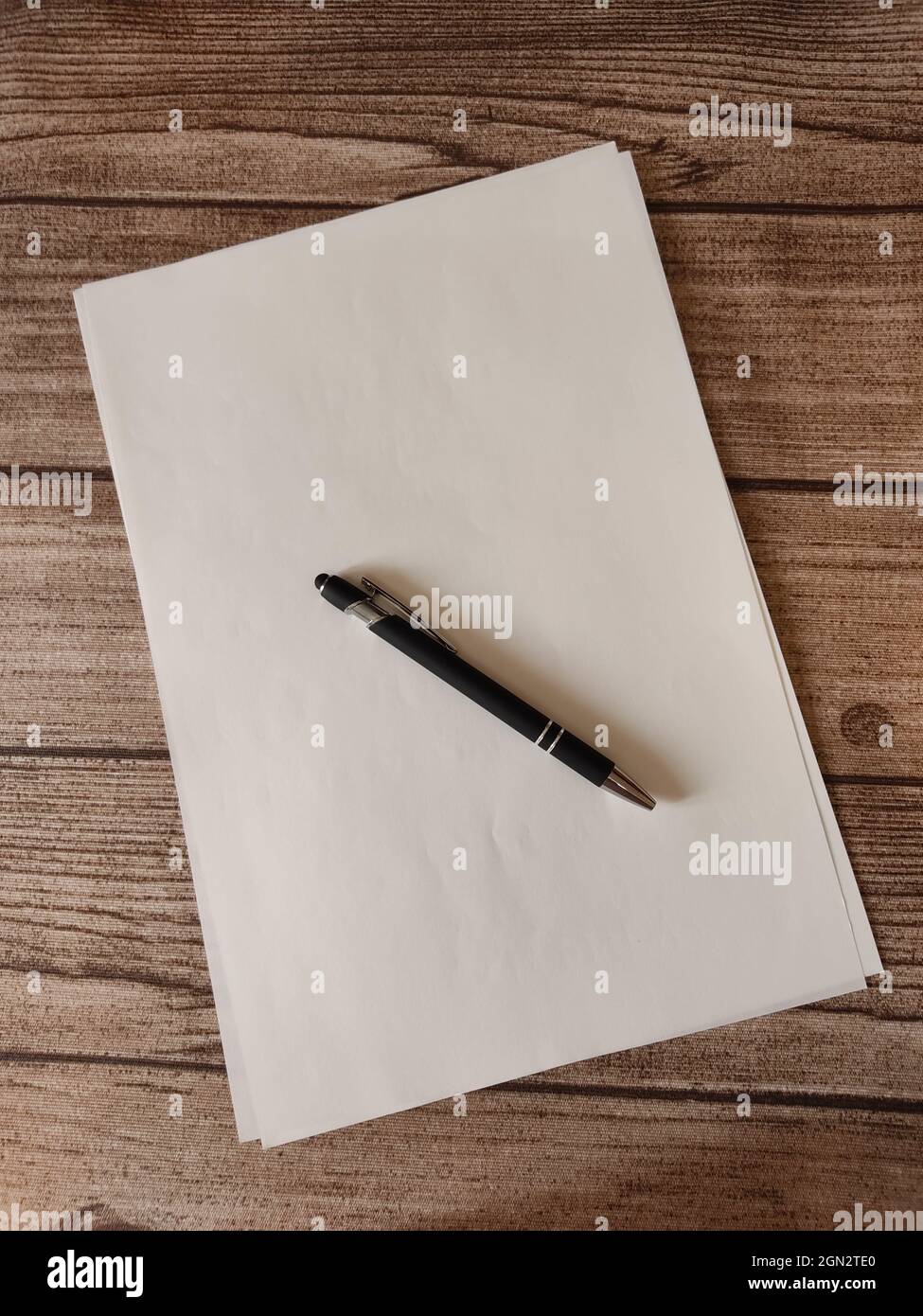 Top view of a blank paper with pen on a wooden table Stock Photo - Alamy