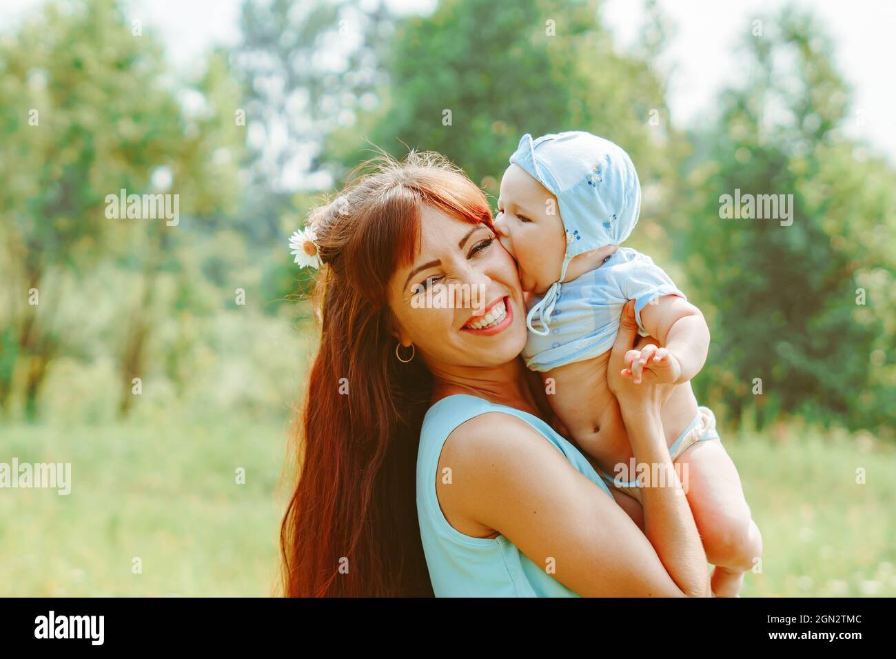 mother raises the child in her arms Stock Photo - Alamy