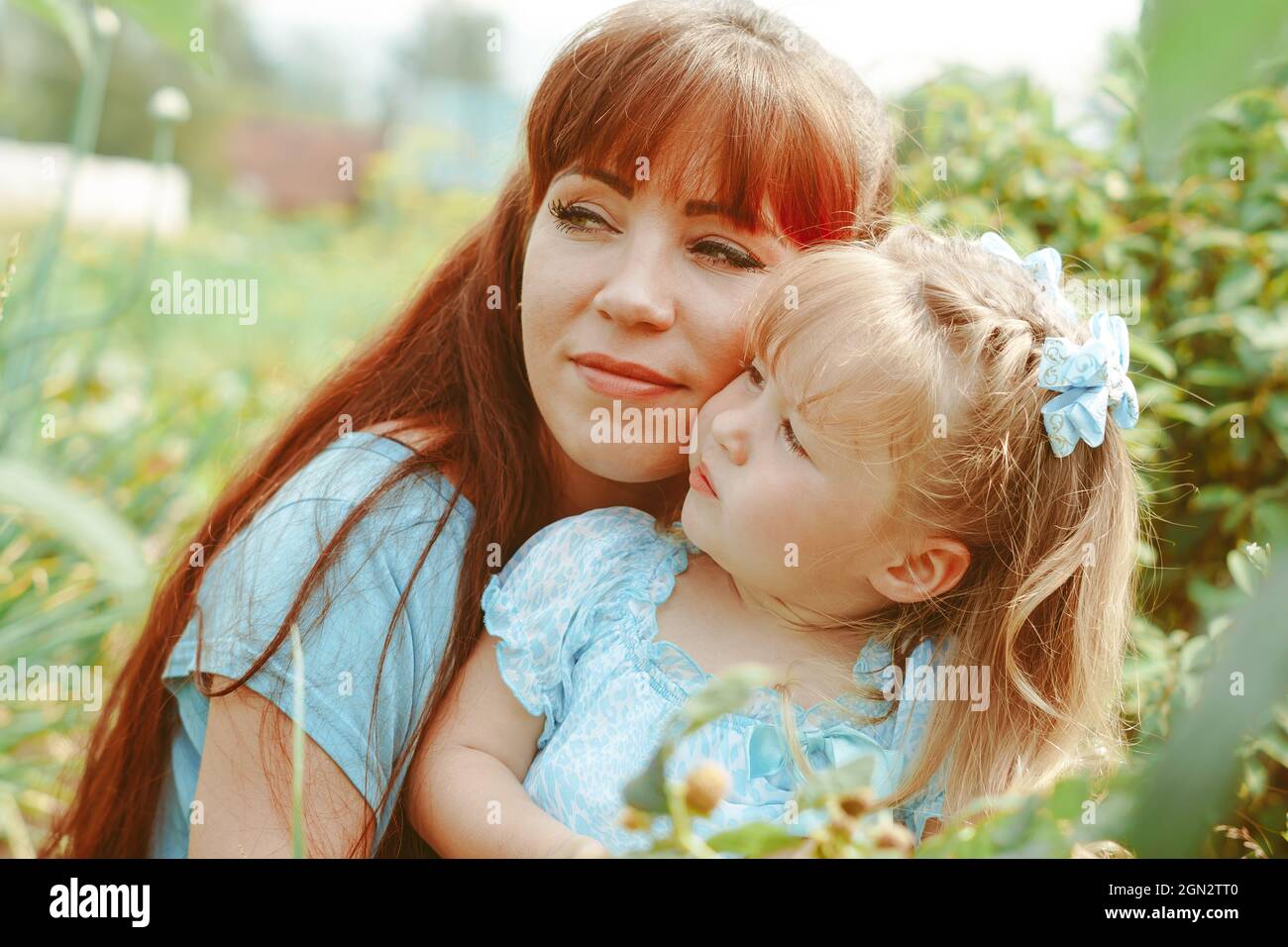 mom hugs her daughter in nature Stock Photo - Alamy