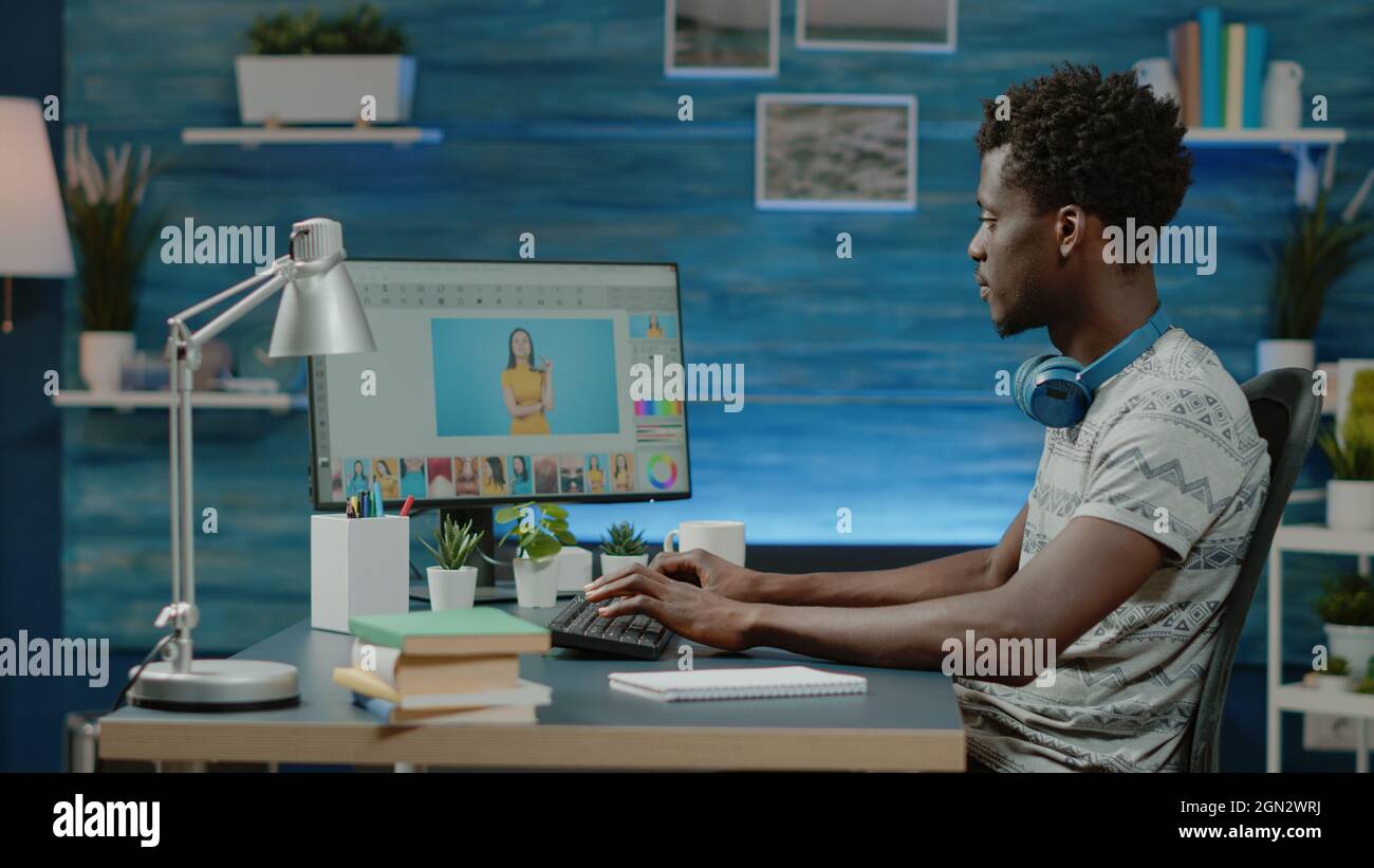 African american photographer retouching pictures on computer screen ...