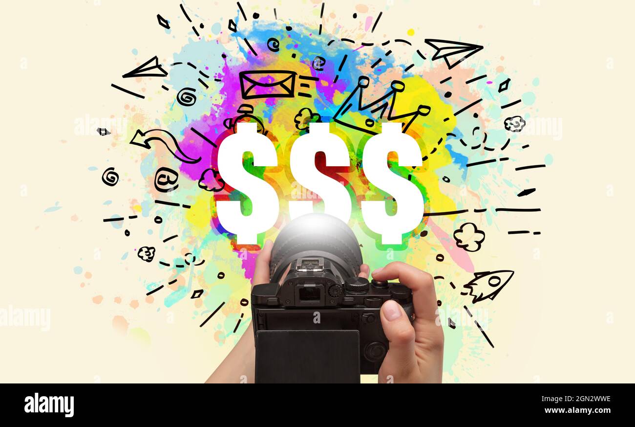 Close-up of a hand holding digital camera with abstract drawing concept ...