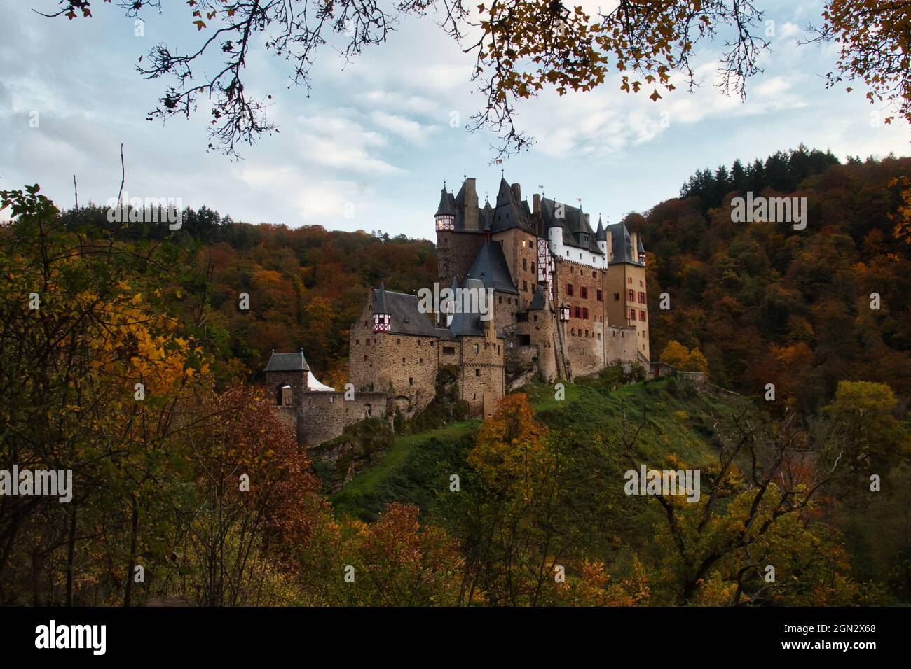 Trees surround Eltz Castle, a 12th century hilltop castle in the valley ...