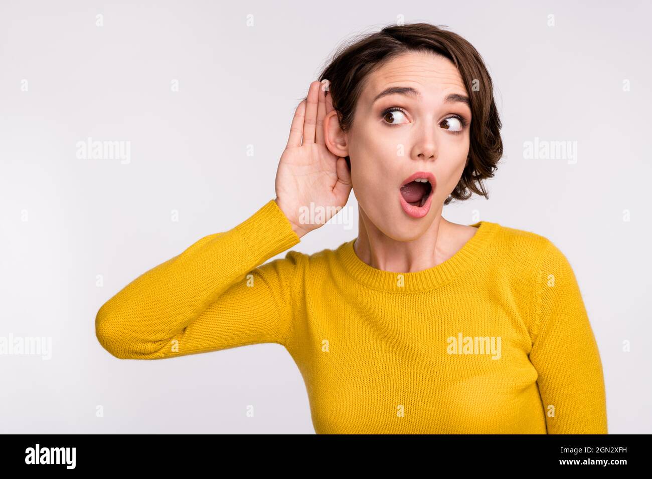 Photo Of Impressed Brunette Millennial Lady Listen Wear Yellow Shirt