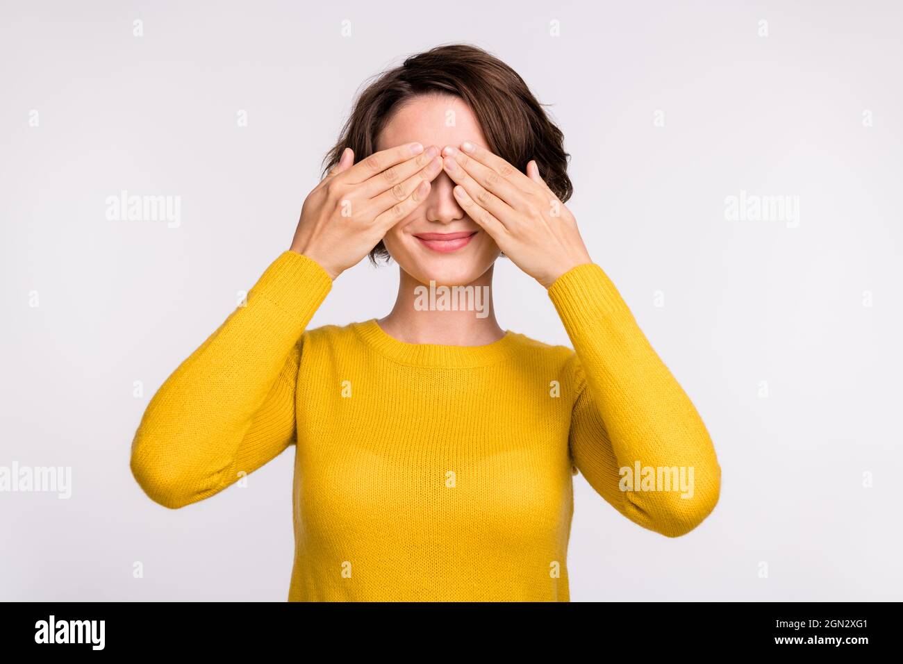 Photo of cheerful interested girl hands cover eyes peaceful smile wear ...