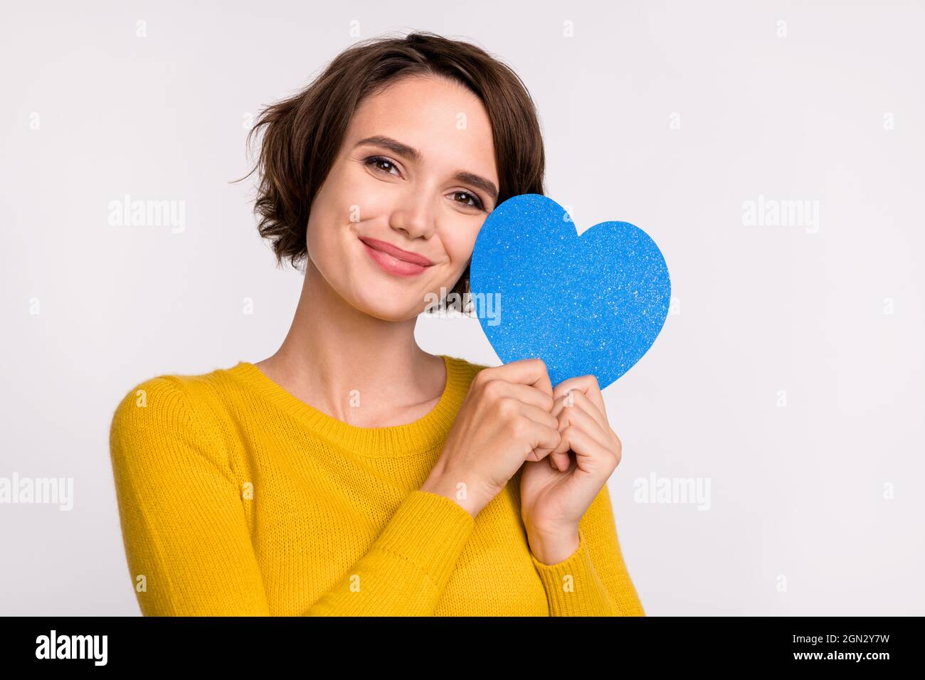 Photo Of Flirty Brunette Young Lady Hug Heart Wear Yellow Shirt