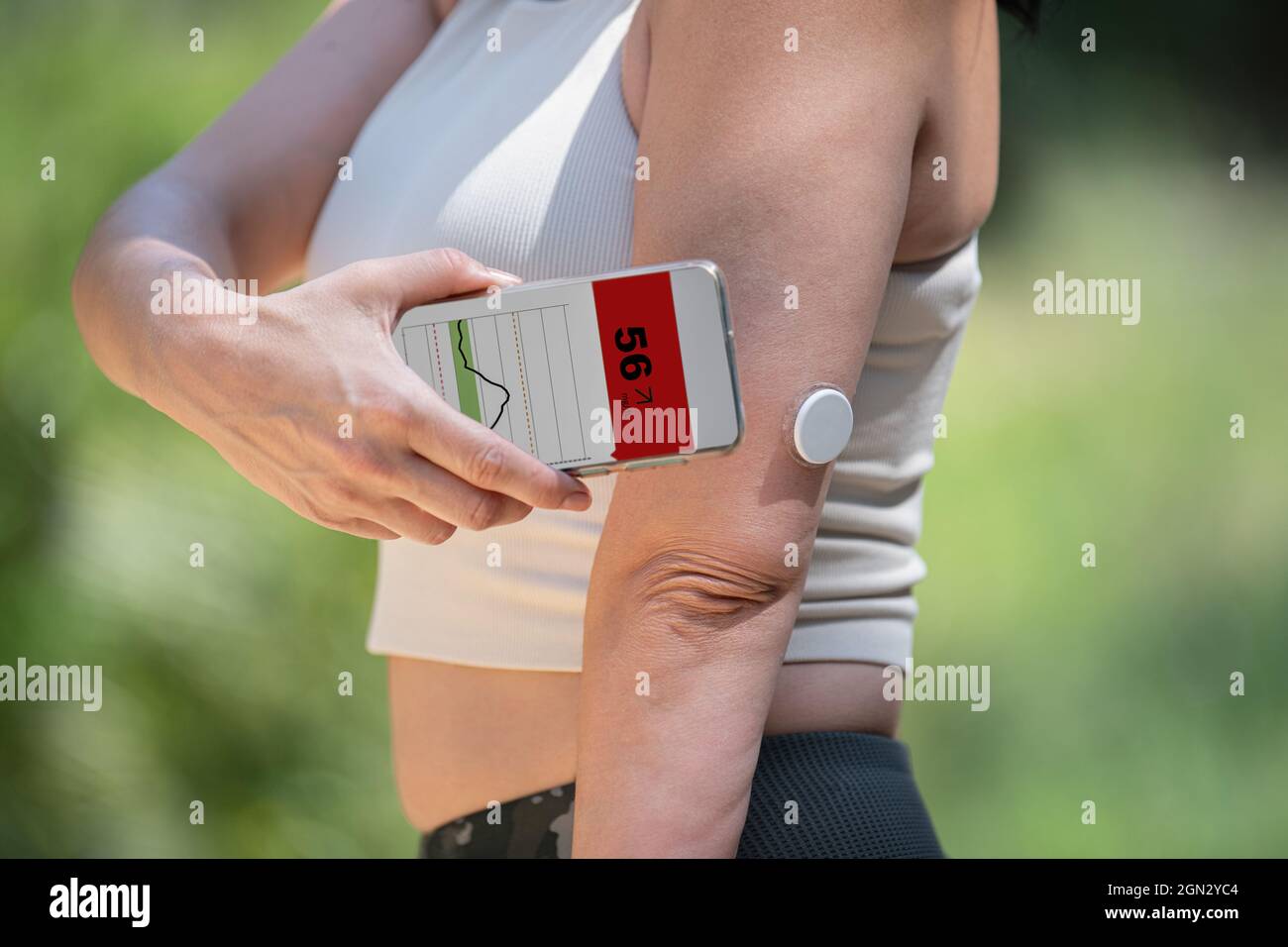 Diabetic woman monitoring and checking glucose level with a remote ...