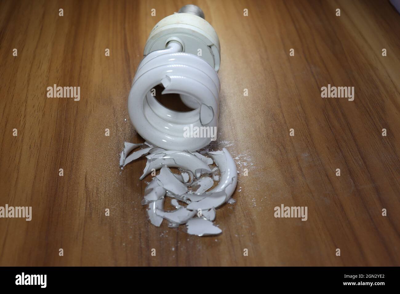 white colored destroyed energy bulb on table Stock Photo - Alamy