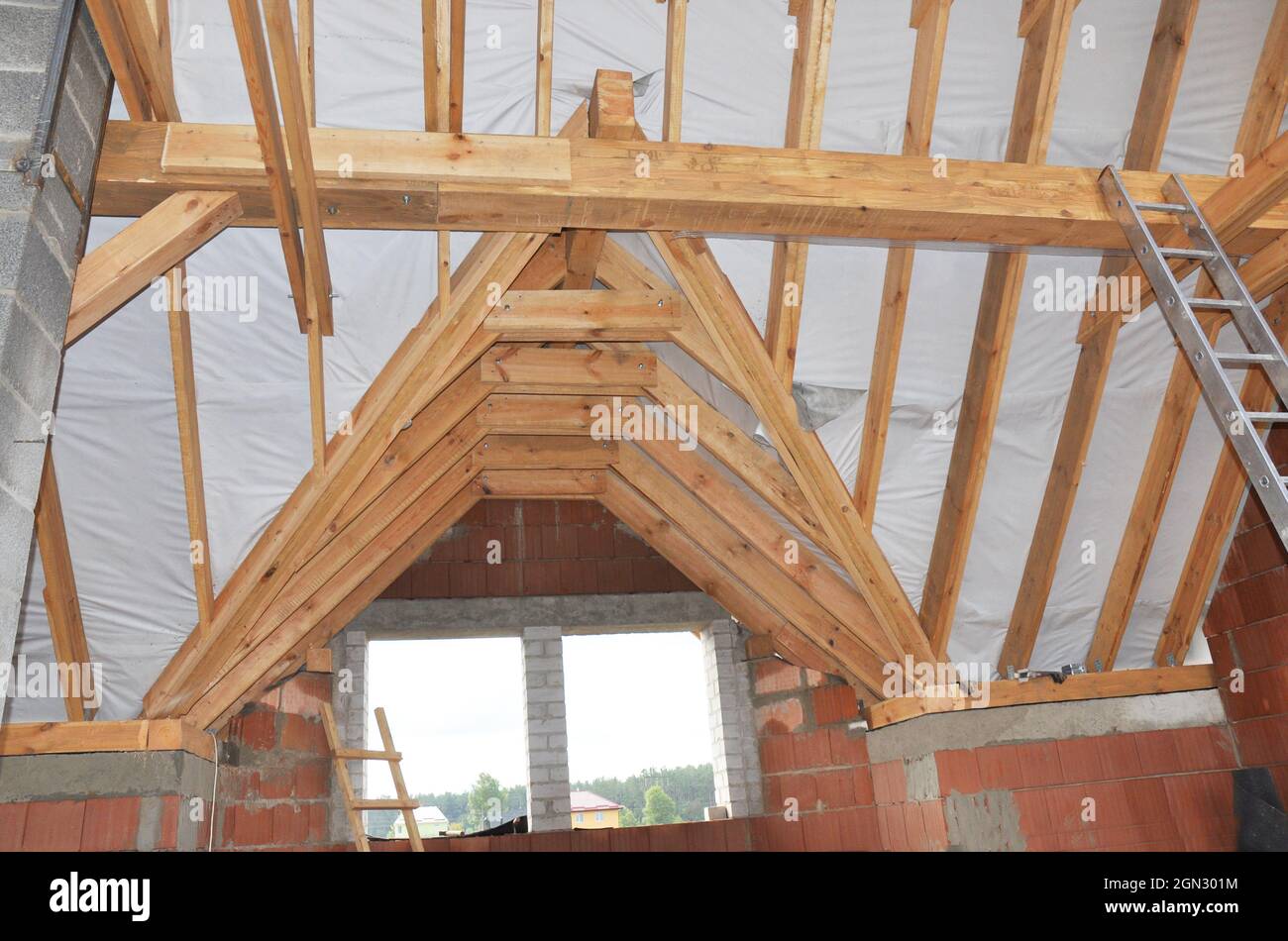 Attic window and roofing trusses construction with woden beams and ...
