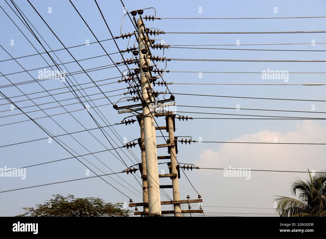 high voltage electric pillar closeup on green field for current supply ...
