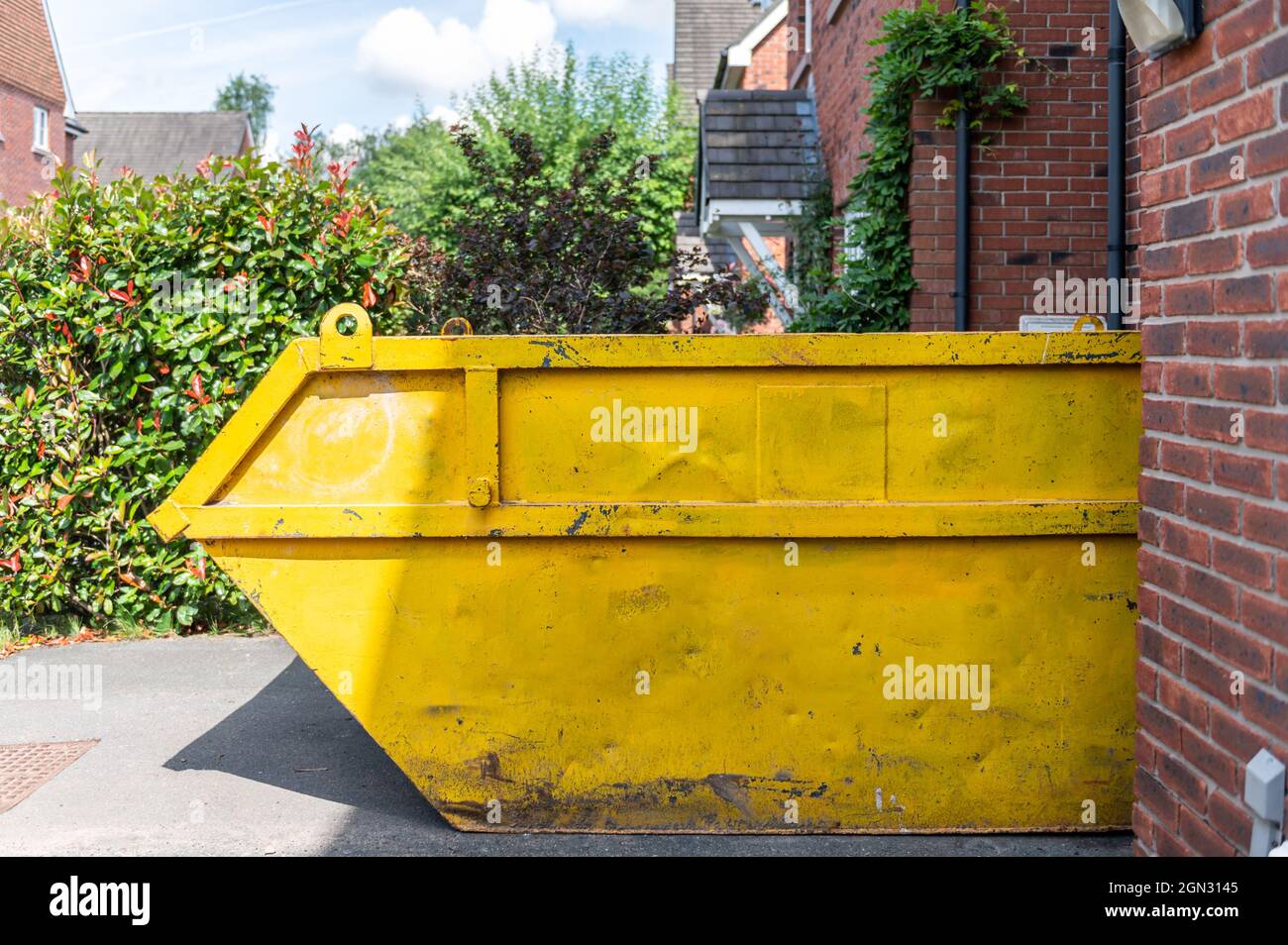 Big Yellow rubbish skip Stock Photo - Alamy