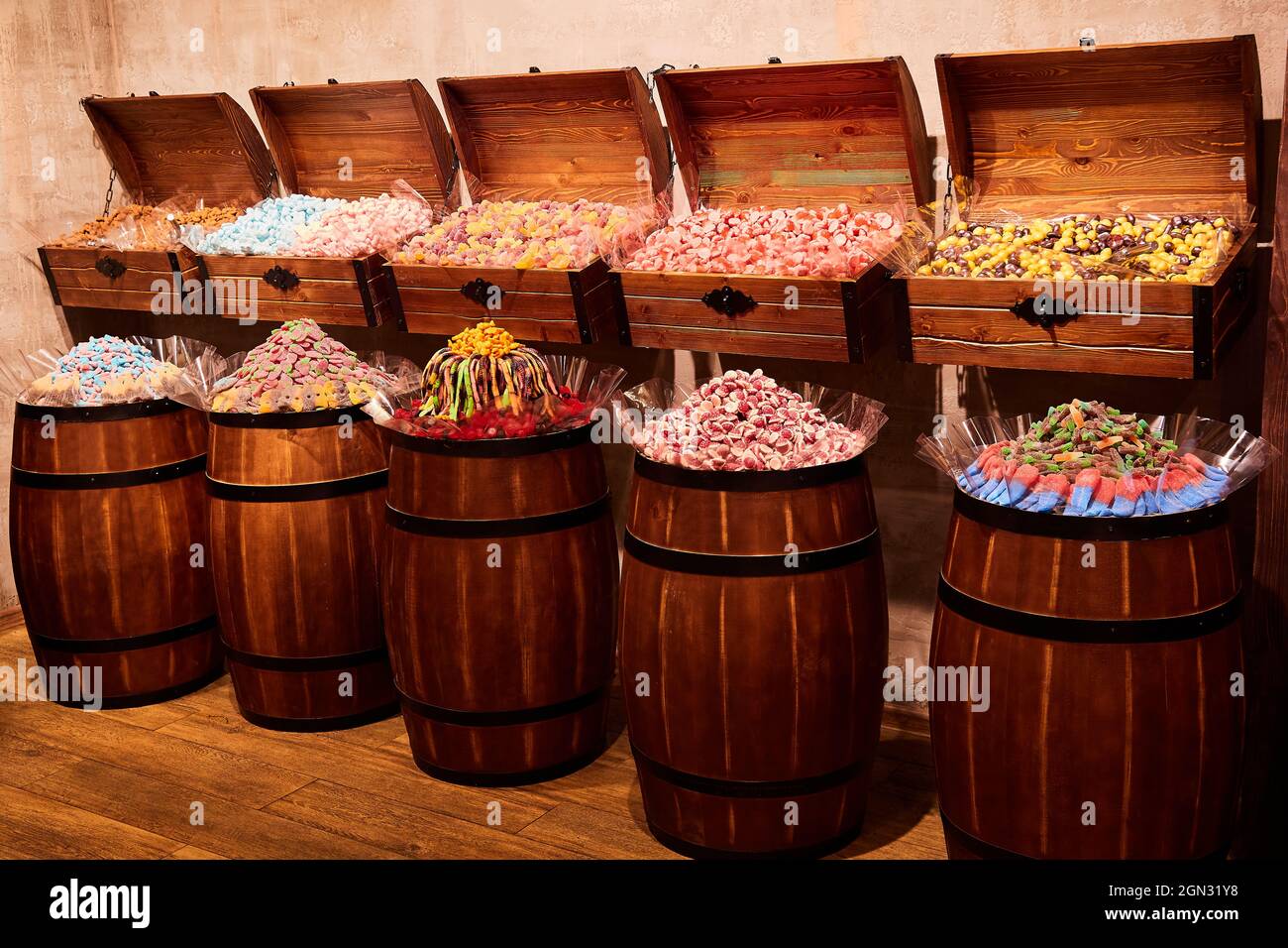 Multicolored gummy candies and marshmallows are sold in the store in ...
