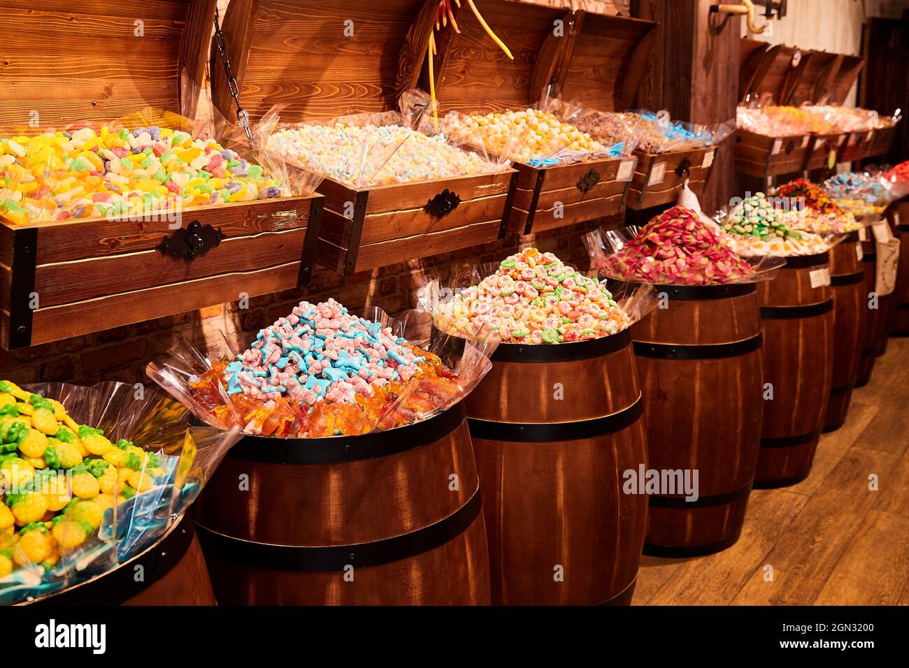 Multicolored gummy candies and marshmallows are sold in the store in ...