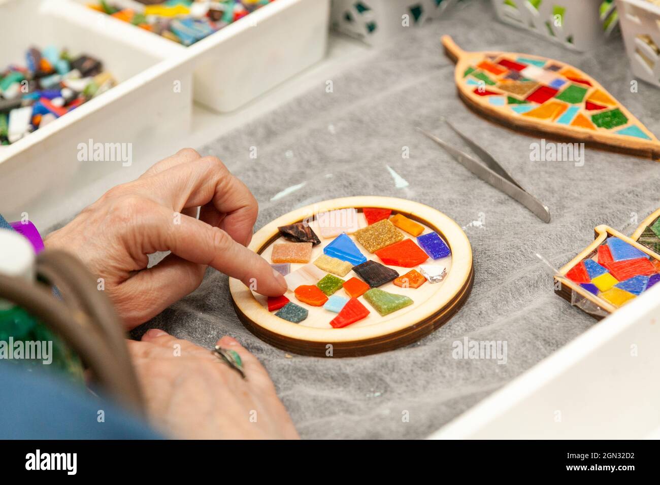 Master class on making mosaic panels. Close-up of the hands of a ...