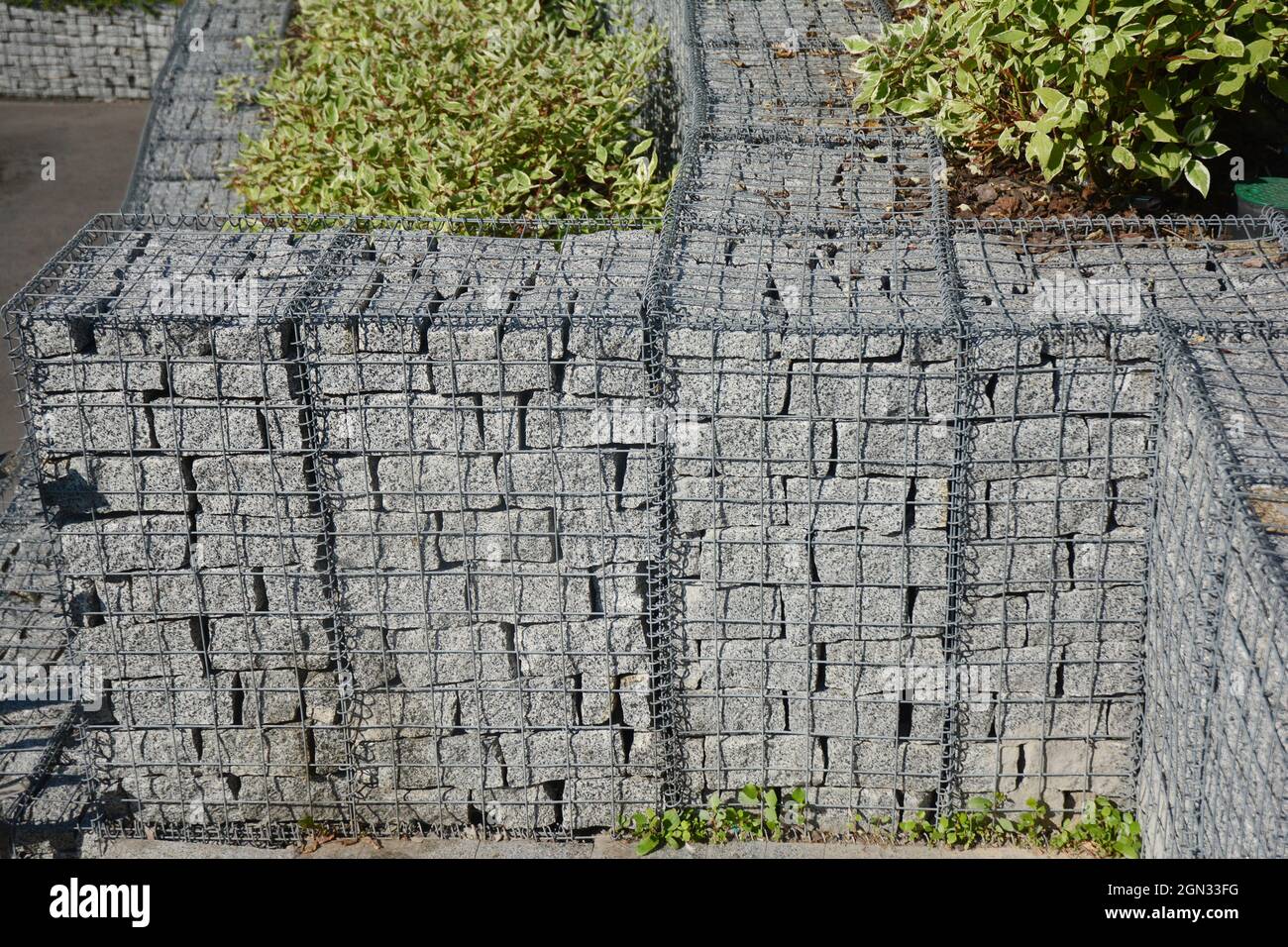 Modern gabion fence wall with stones in wire mesh in the garden design ...