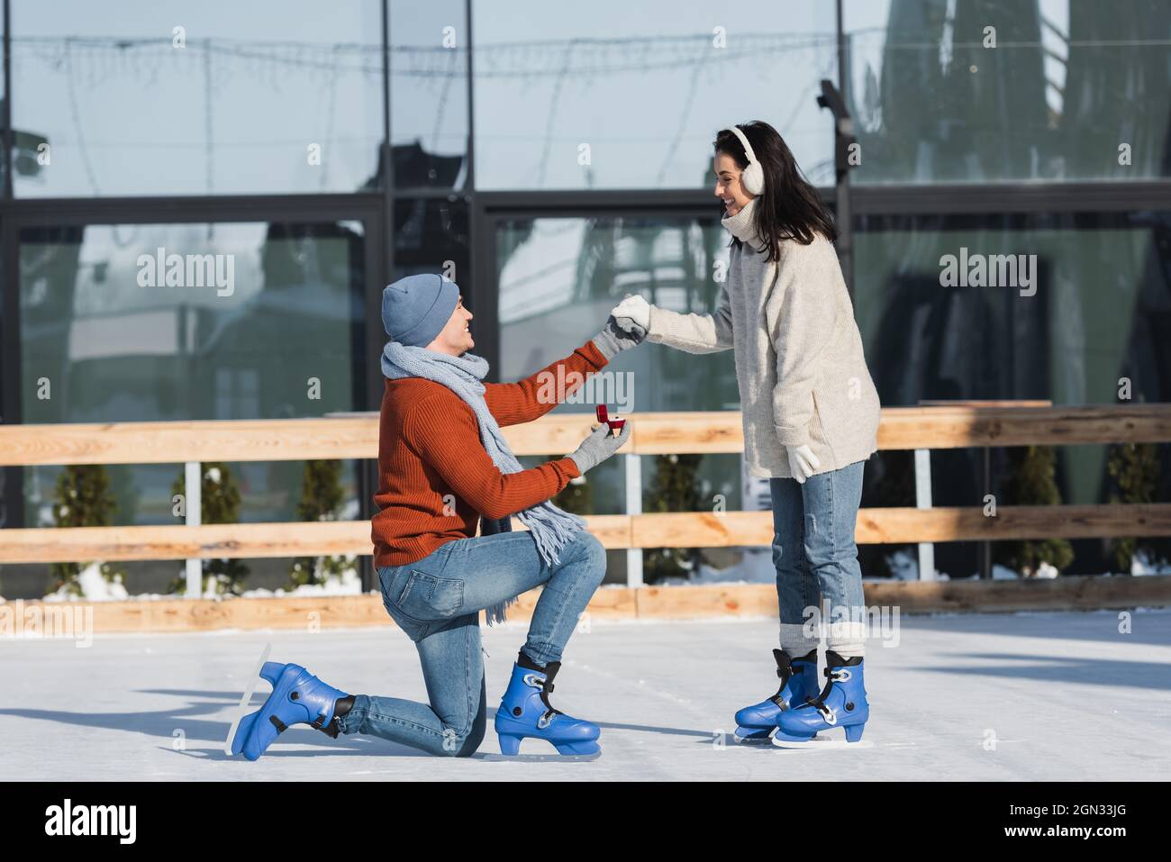 man holding box with wedding ring and kneeling while making proposal to ...