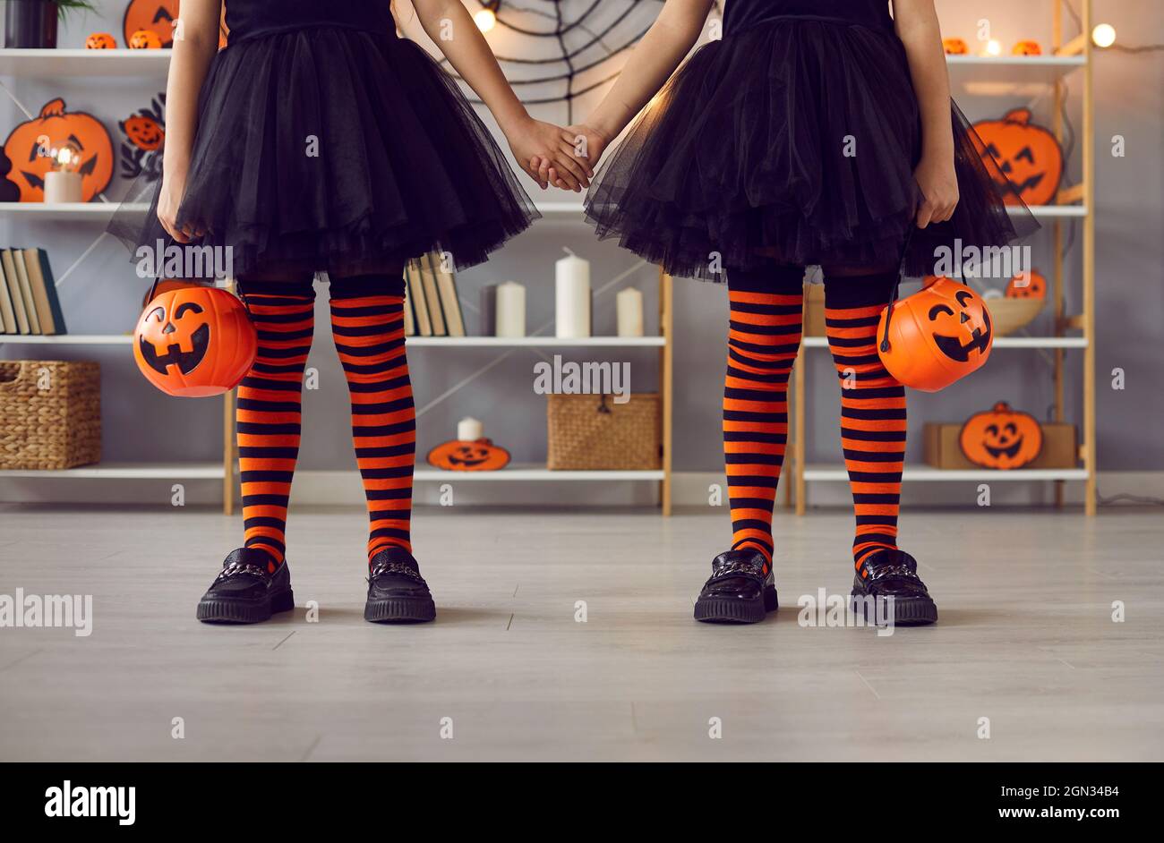 Legs of little girls in Halloween costumes standing holding hands in ...