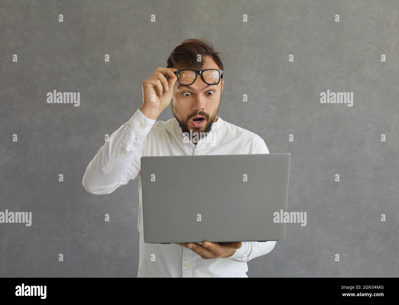 Man looking at screen of his laptop computer with expression of big ...