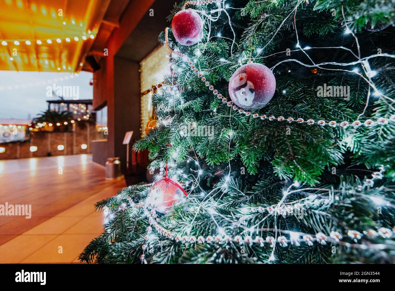 Christmas tree on the street. decorated with balloons and a glowing ...