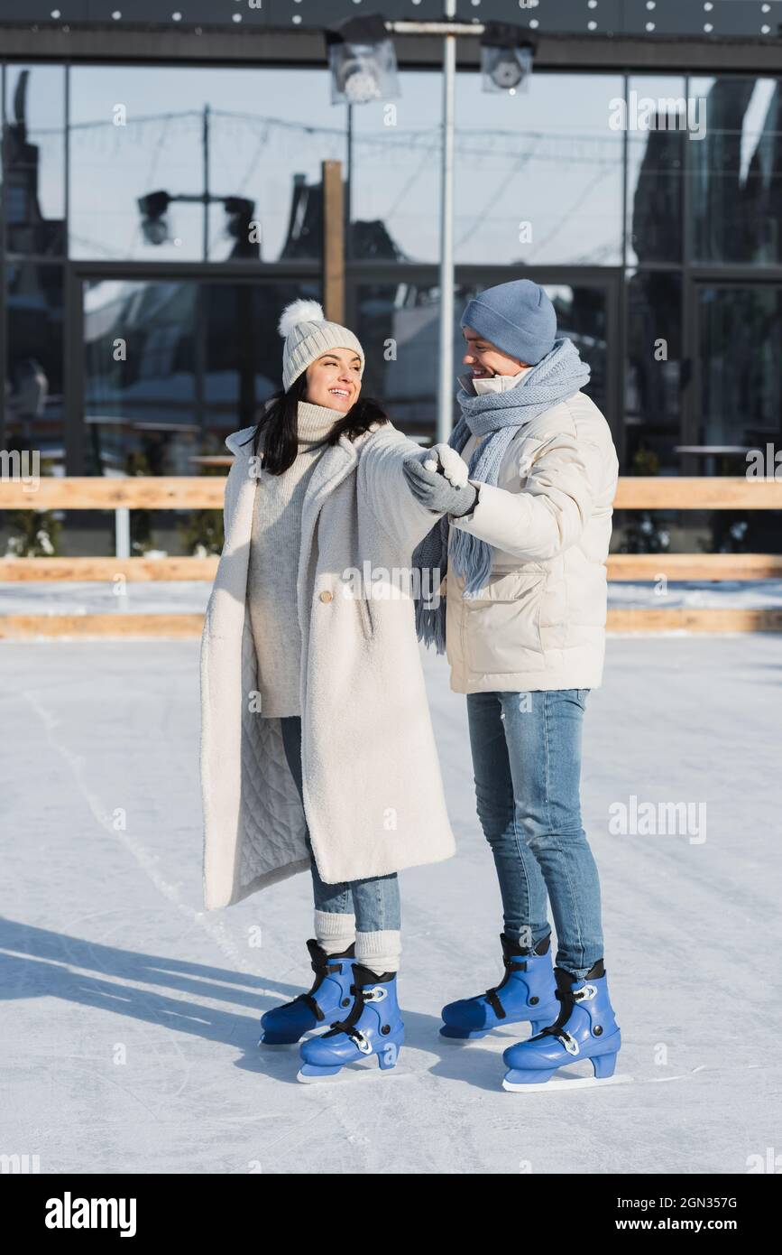 Young couple skates hand hi-res stock photography and images - Alamy