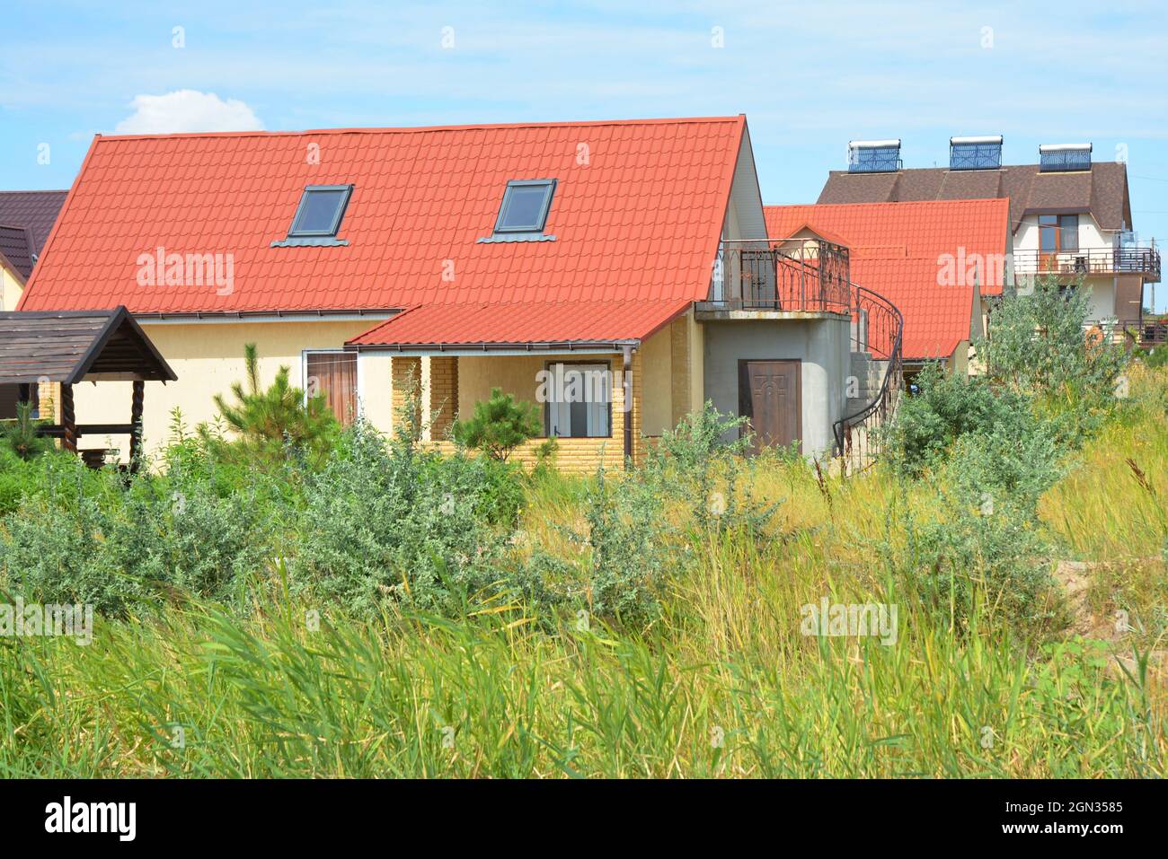 Rural modern house with red roof, balcony and skylight Stock Photo - Alamy