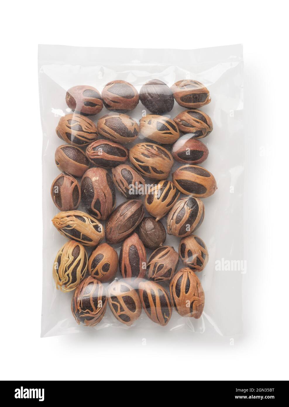 Top view of nutmeg seeds with mace in plastic bag isolated on white ...