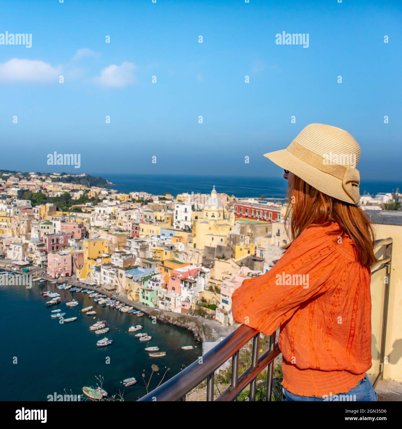Beautiful young girl over panoramic view of Procida Island, Naples ...
