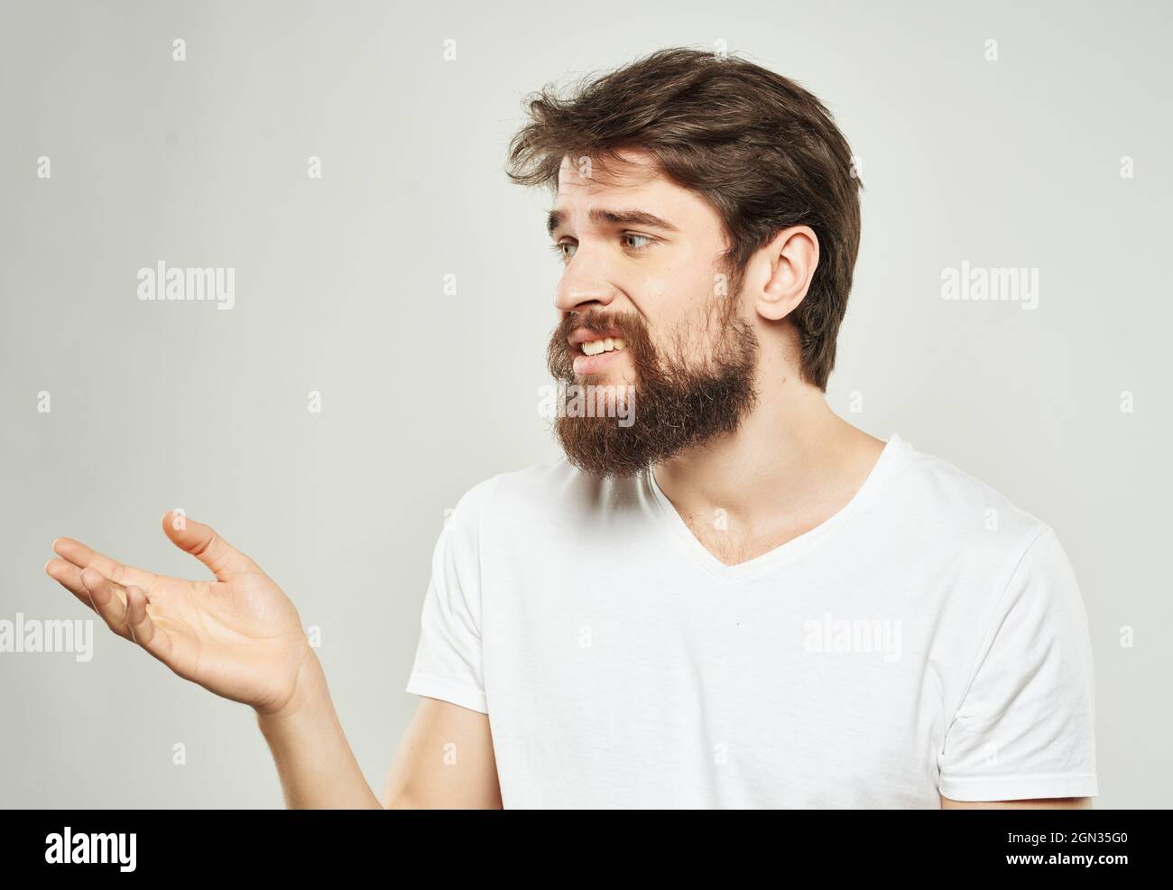 bearded man in a white t-shirt hand gestures anger close-up Stock Photo ...