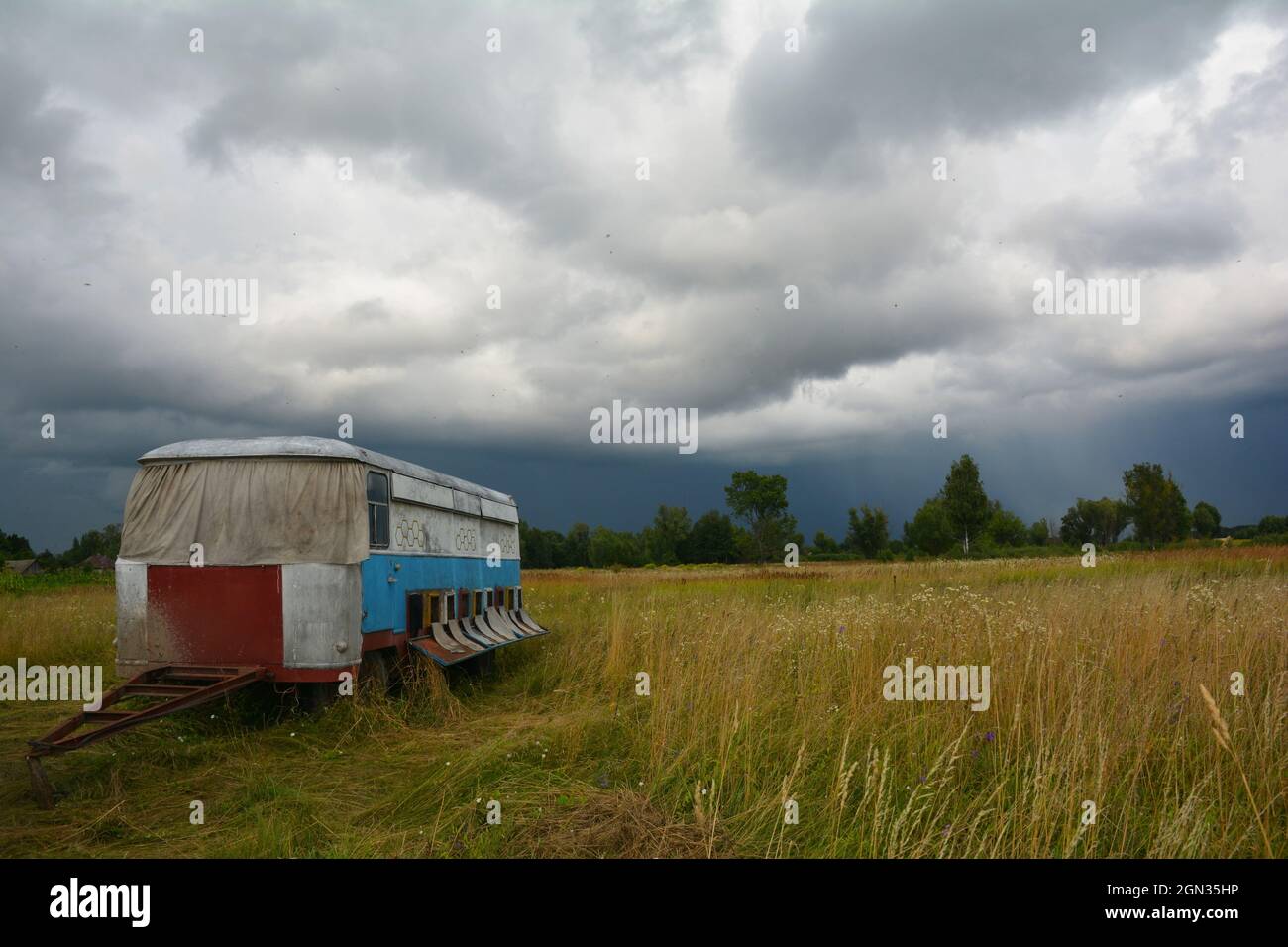 Old bus with honey bees beehives in the field with rain and stormy ...