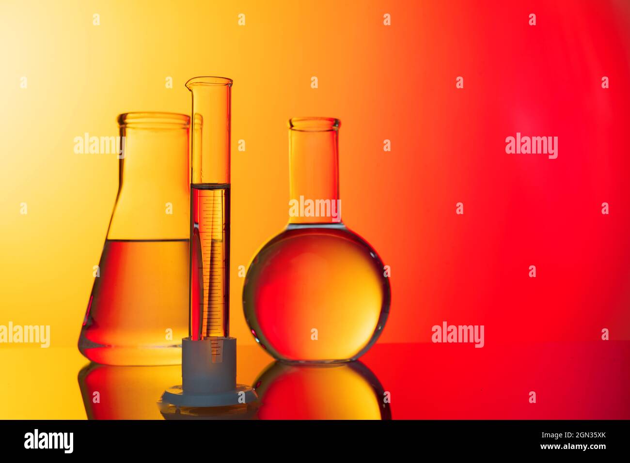 Science concept. Glass test tubes on red background Stock Photo - Alamy
