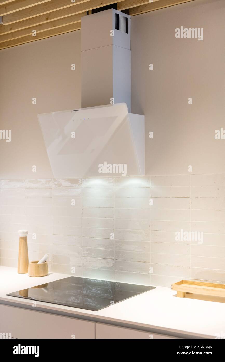 Detail of electric hob and extractor in modern kitchen Stock Photo - Alamy