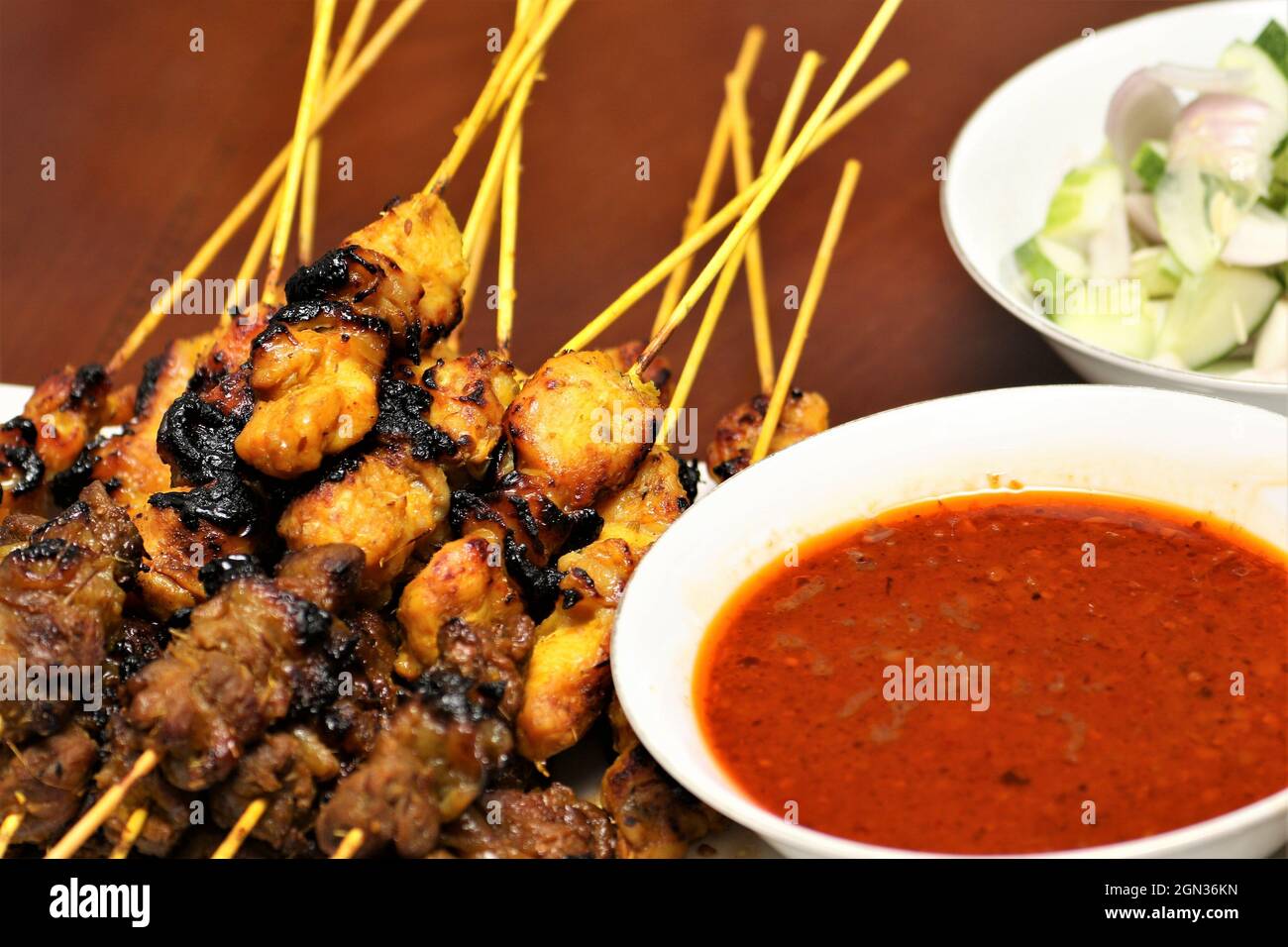 Traditional Malaysian barbeque dish called sate, served with spicy ...