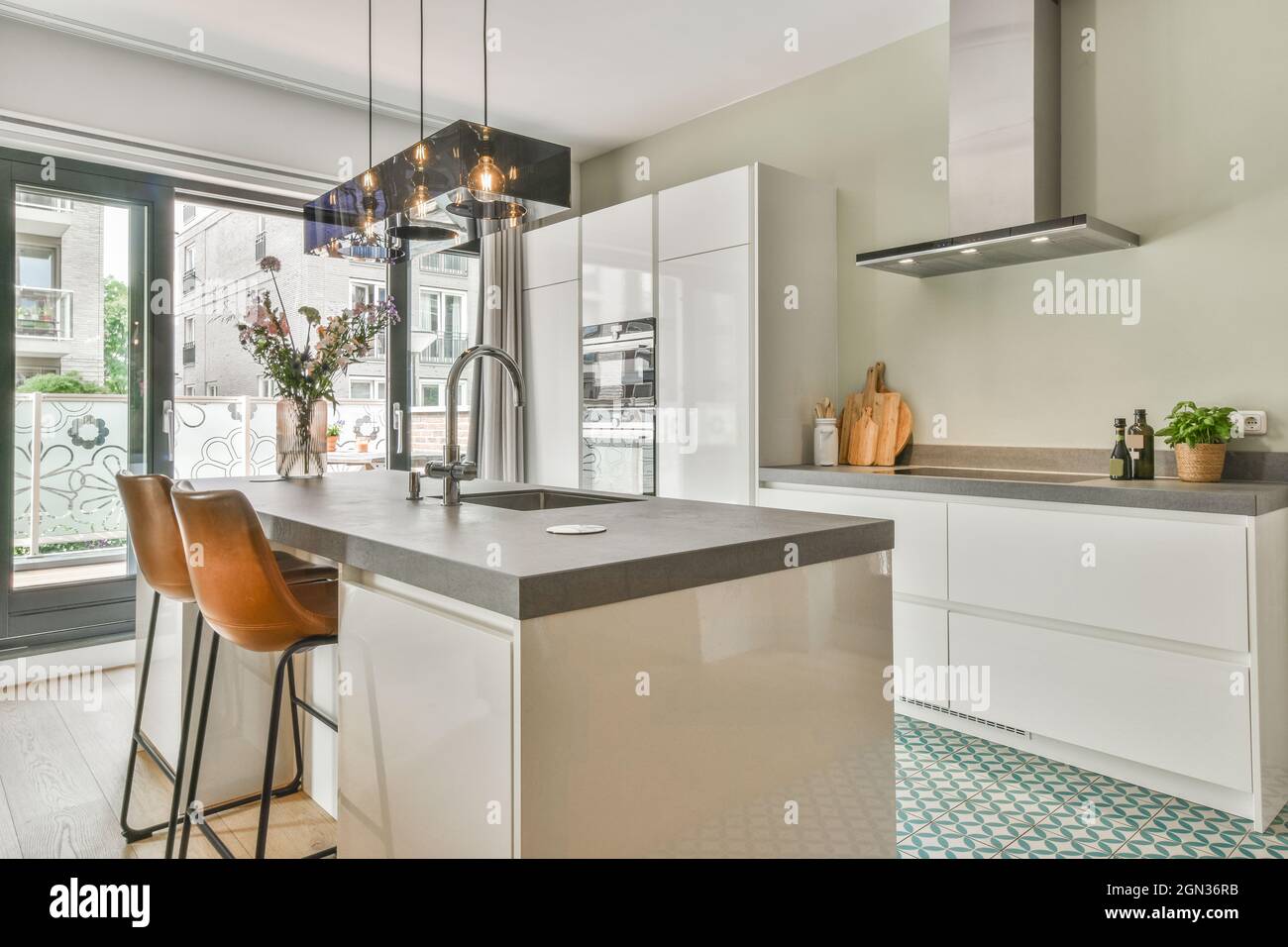 Stylish interior of modern kitchen with white cabinets and appliances ...