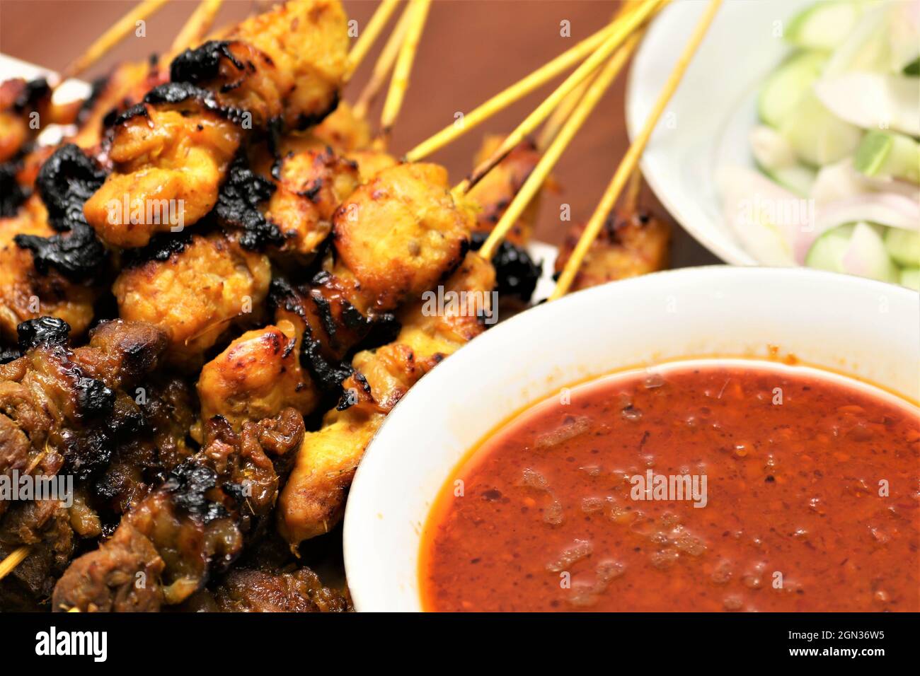 Traditional Malaysian barbeque dish called sate, served with spicy ...