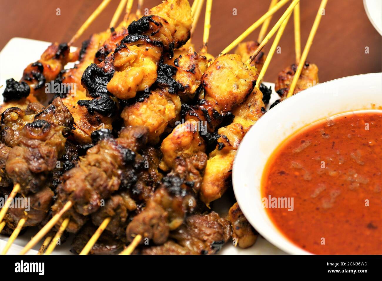 Traditional Malaysian barbeque dish called sate, served with spicy ...