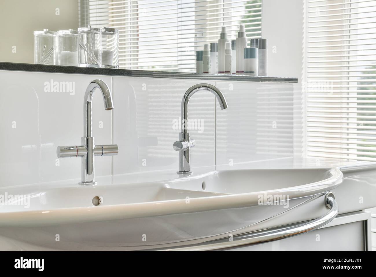 Modern white double sinks in bathroom with taps designed in minimal ...