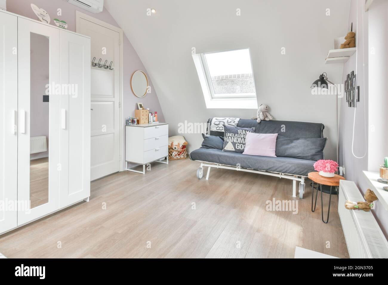 Contemporary room interior with closet and decorative cushions on couch ...