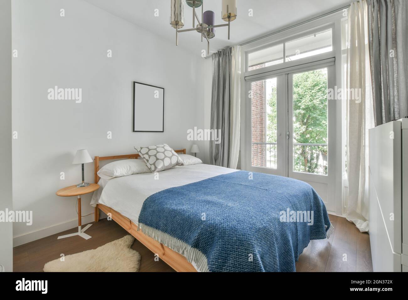 Interior of stylish bedroom with comfortable bed near window and light ...